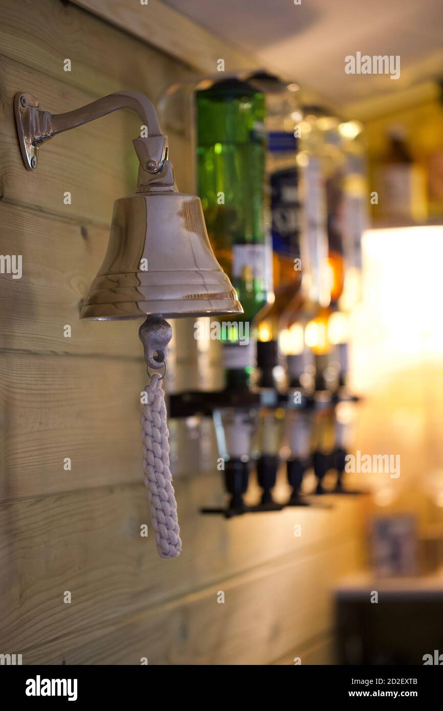 Pub bell with spirits in optics Stock Photo - Alamy