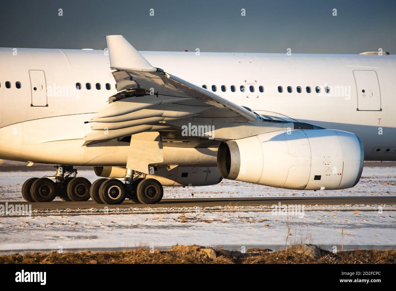 Closeup of landing gear, engine, wing, winglet and fuselage of ...