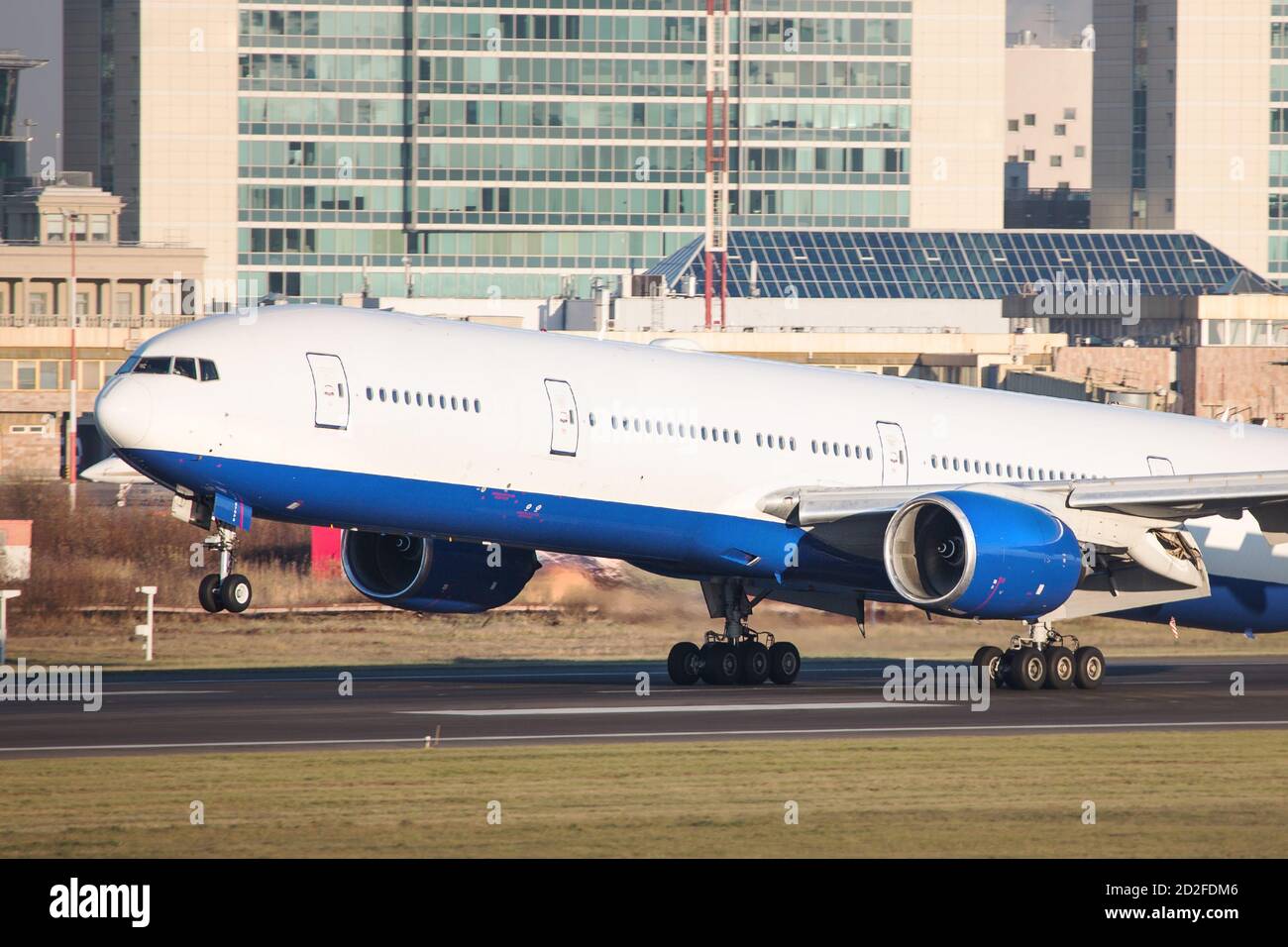 Passenger airplane with two engines landing on runway with touchdown ...