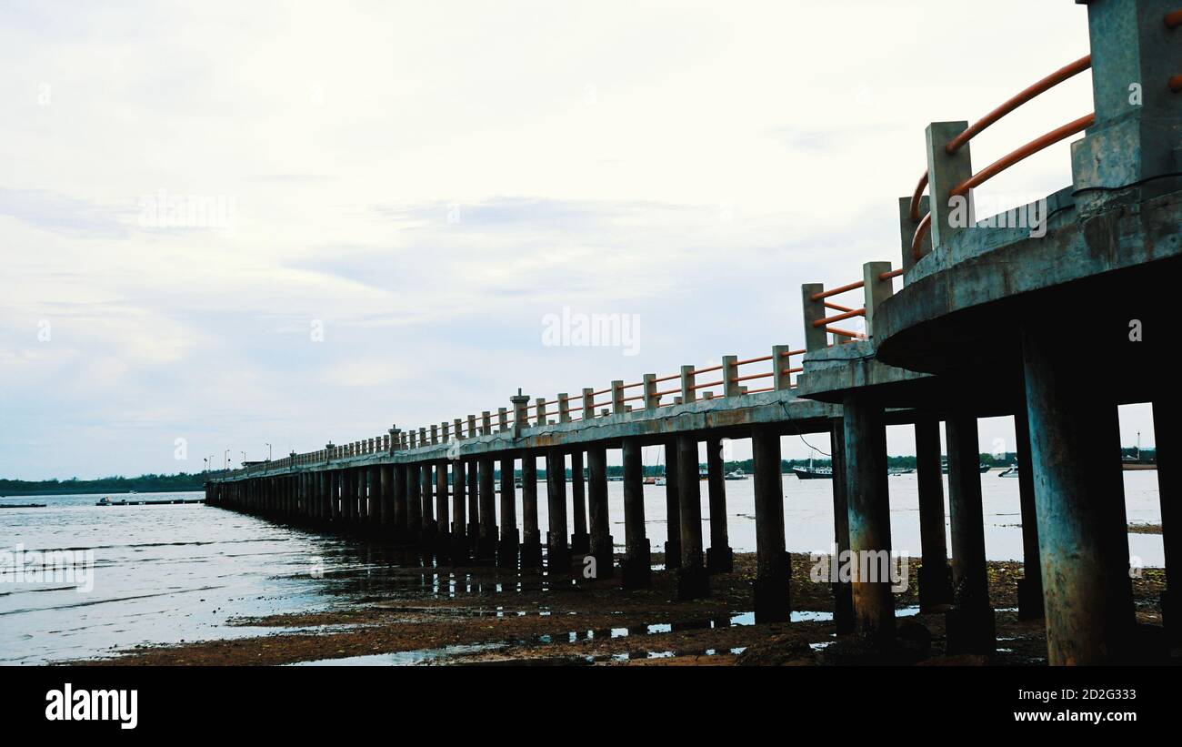 View of pier poles at low tide on the beach Stock Photo - Alamy
