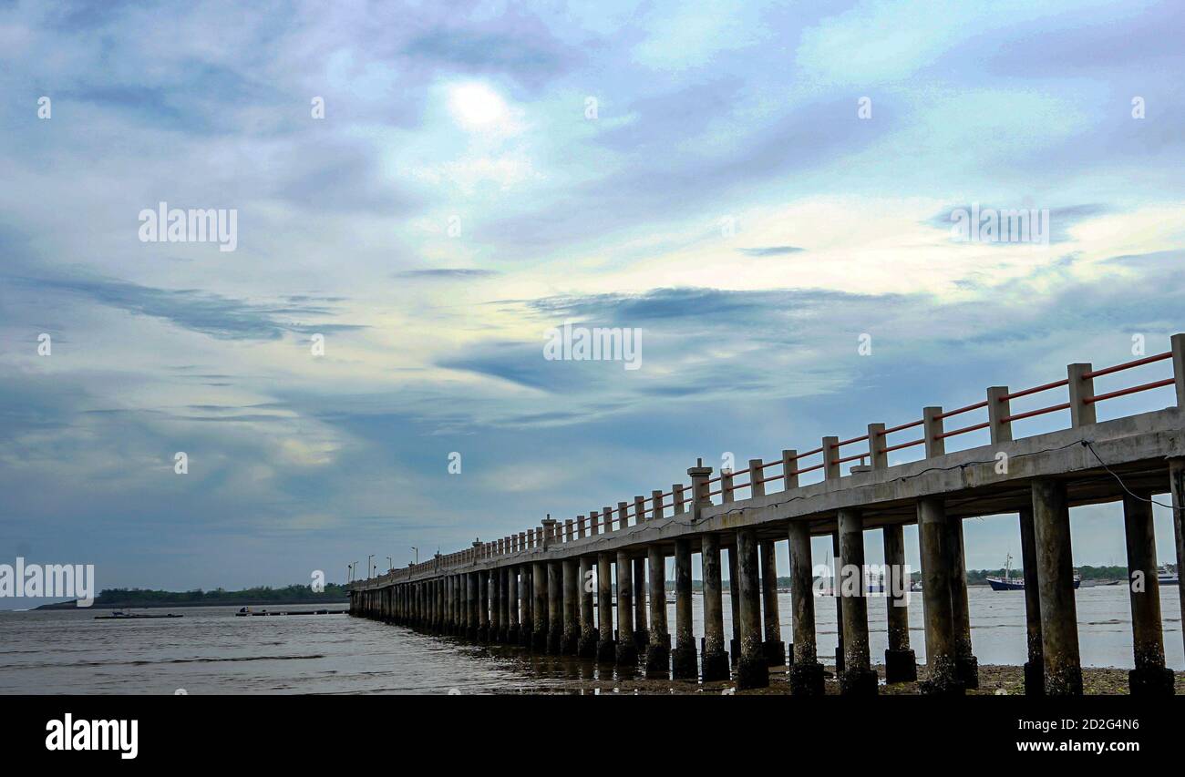 View of pier poles at low tide on the beach Stock Photo - Alamy