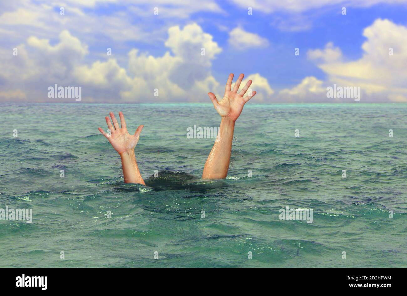 drowning man hands stretched out to the surface for help at sea Stock ...