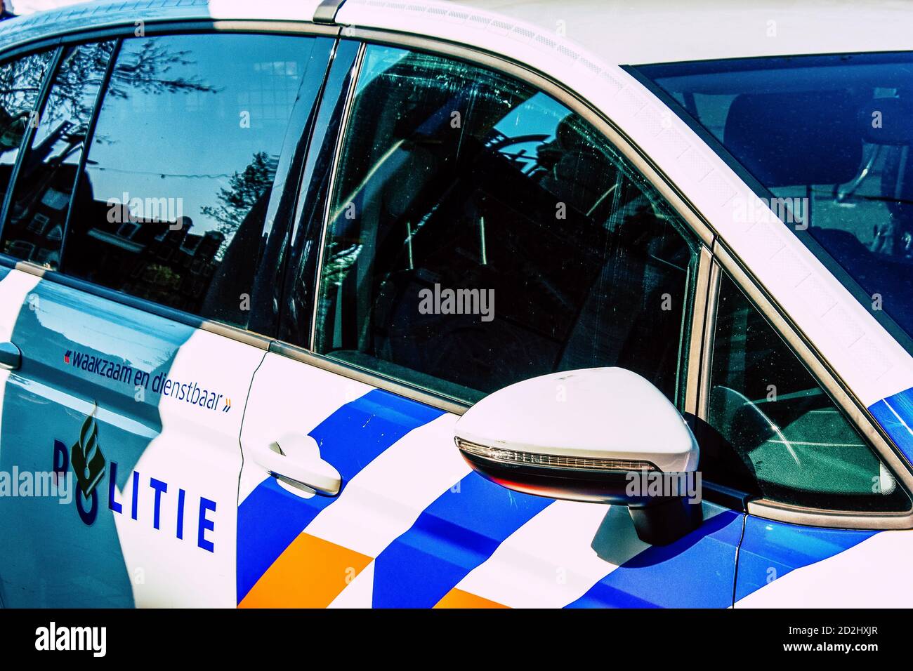 Closeup of an official police car patrolling the streets of the city ...