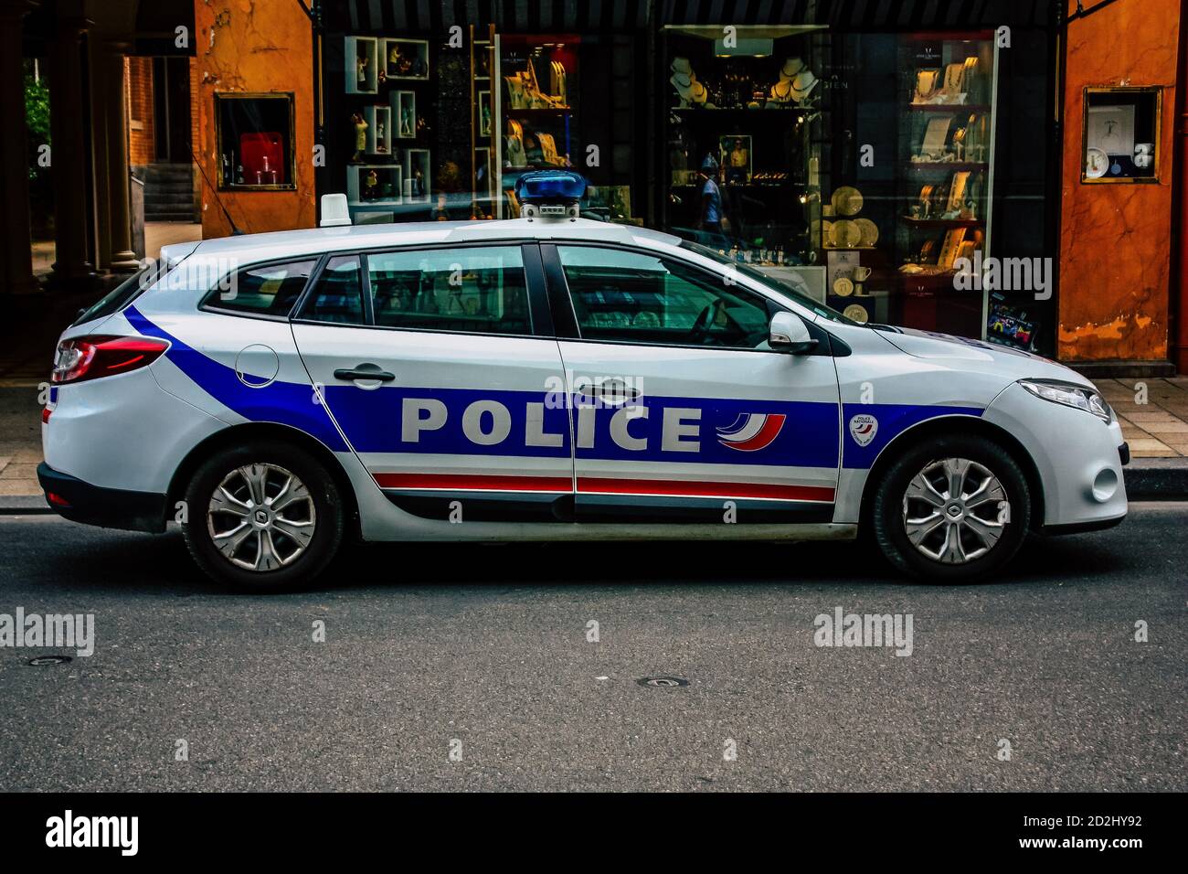 Closeup of an official police car patrolling the streets of the city ...