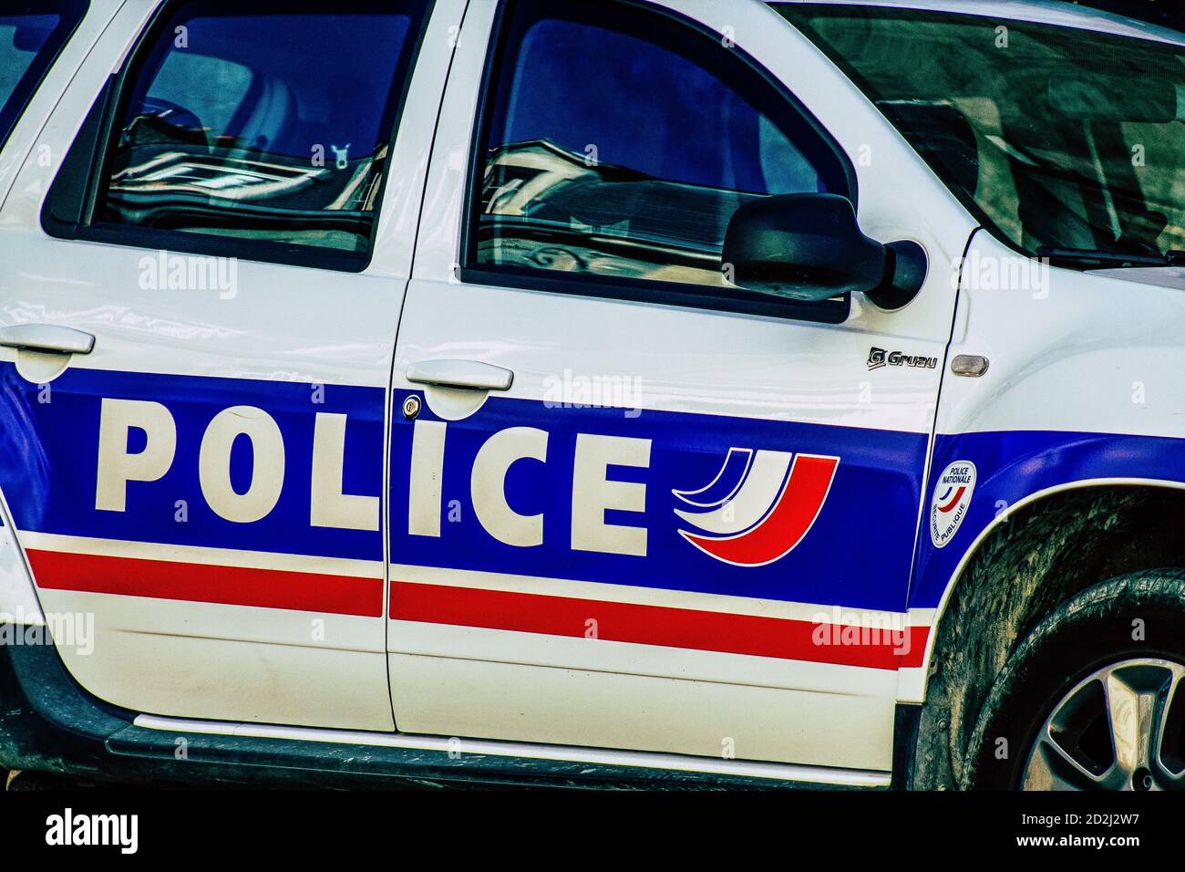 Closeup of an official police car patrolling the streets of the city ...