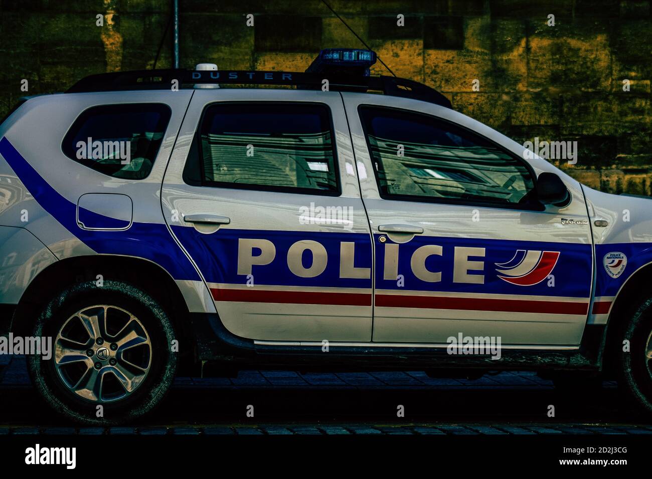 Closeup of an official police car patrolling the streets of the city ...