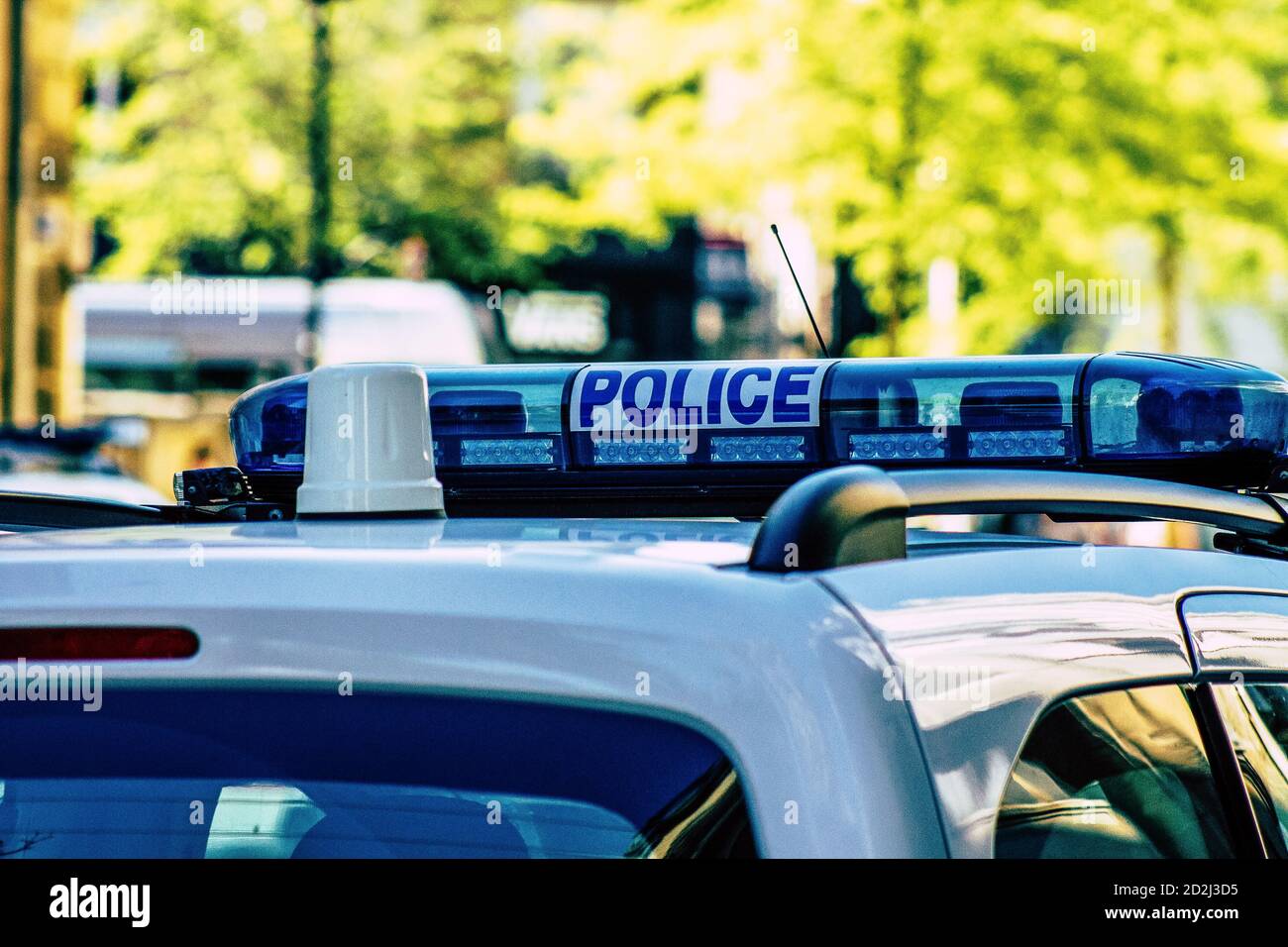 Closeup of an official police car patrolling the streets of the city ...