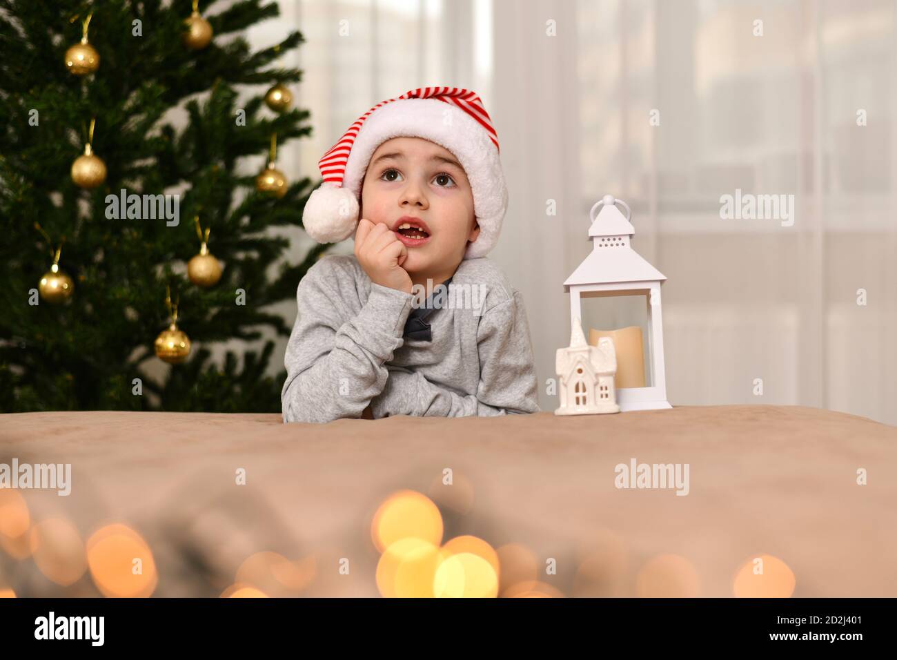 Little boy making a wish. He put his hand under his head. Dressed in a ...