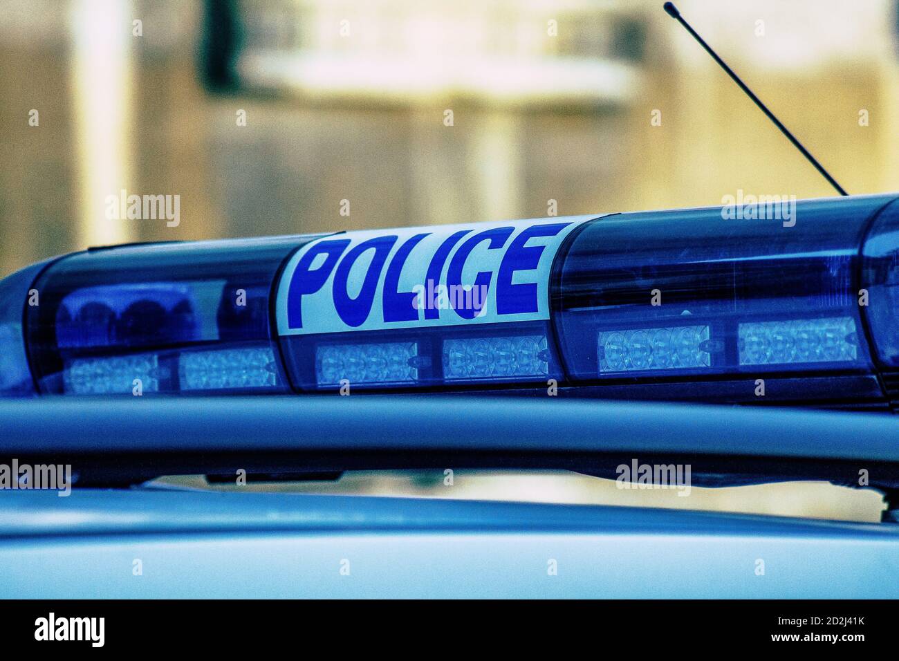 Closeup of an official police car patrolling the streets of the city ...