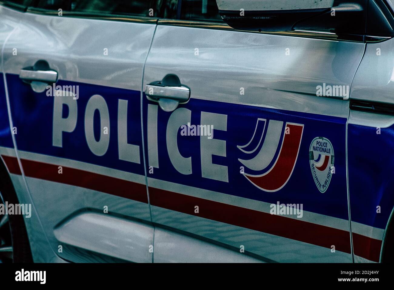 Closeup of an official police car patrolling the streets of the city ...
