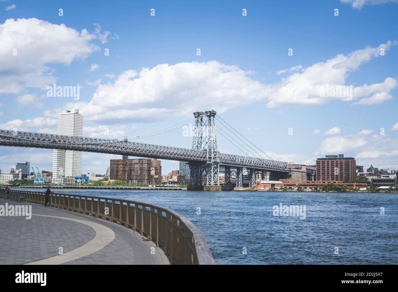An empty promenade along East River in lower Manhattan with a view of Williamsburg Bridge Stock ...