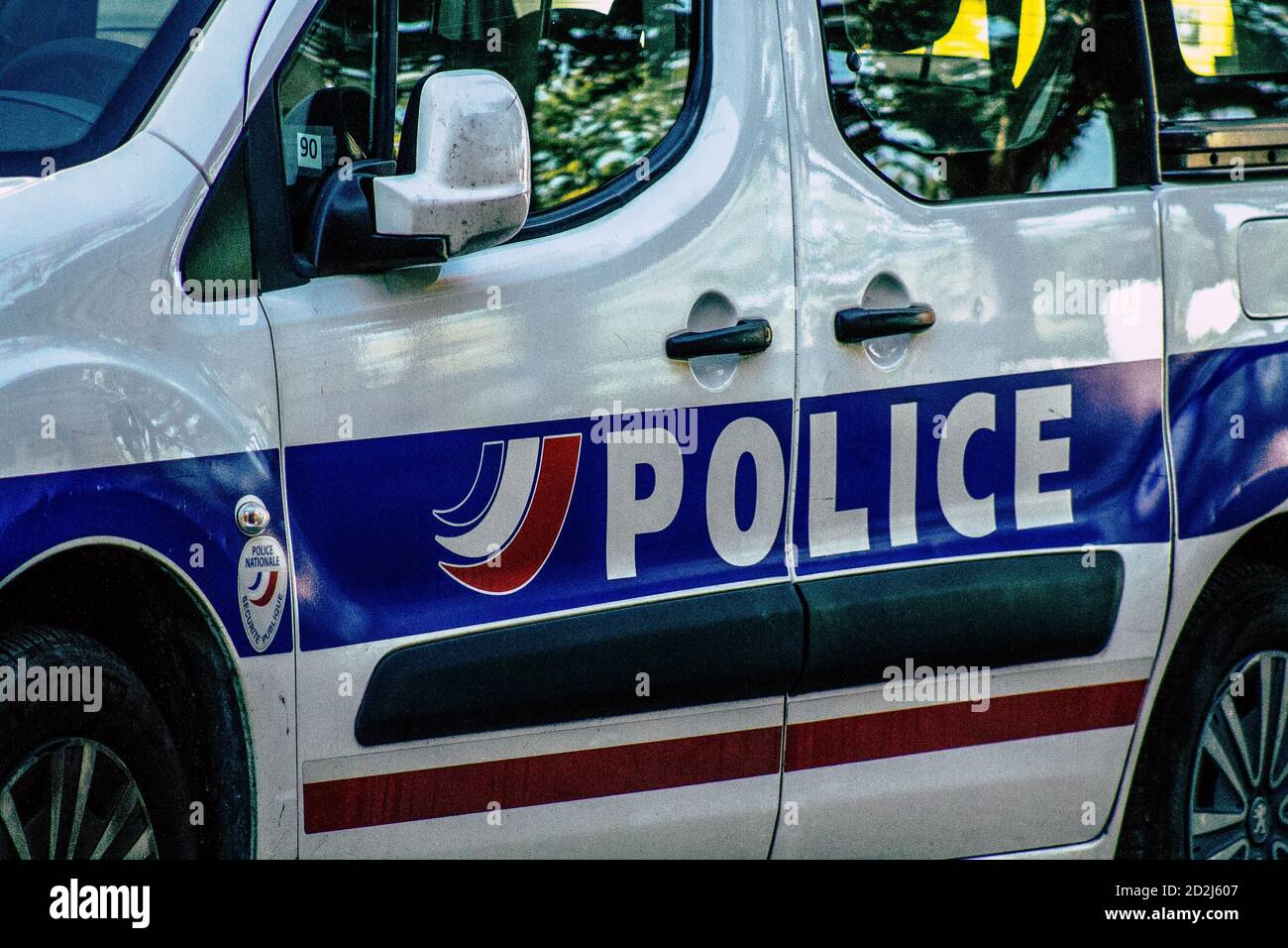 Closeup of an official police car patrolling the streets of the city ...
