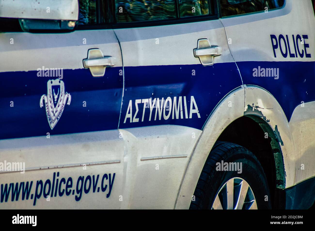 Closeup of an official police car patrolling the streets of the city ...