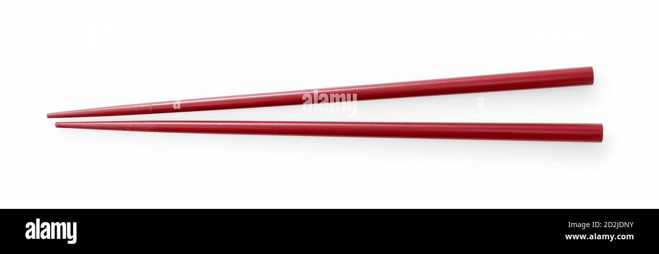 Red chopsticks on a white background Stock Photo - Alamy