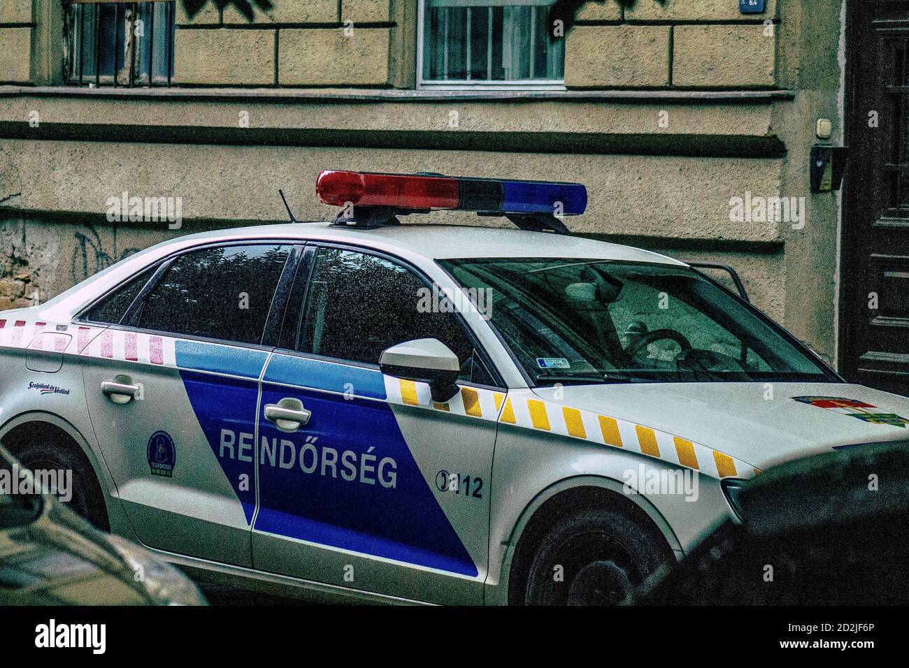 Closeup of an official police car patrolling the streets of the city ...