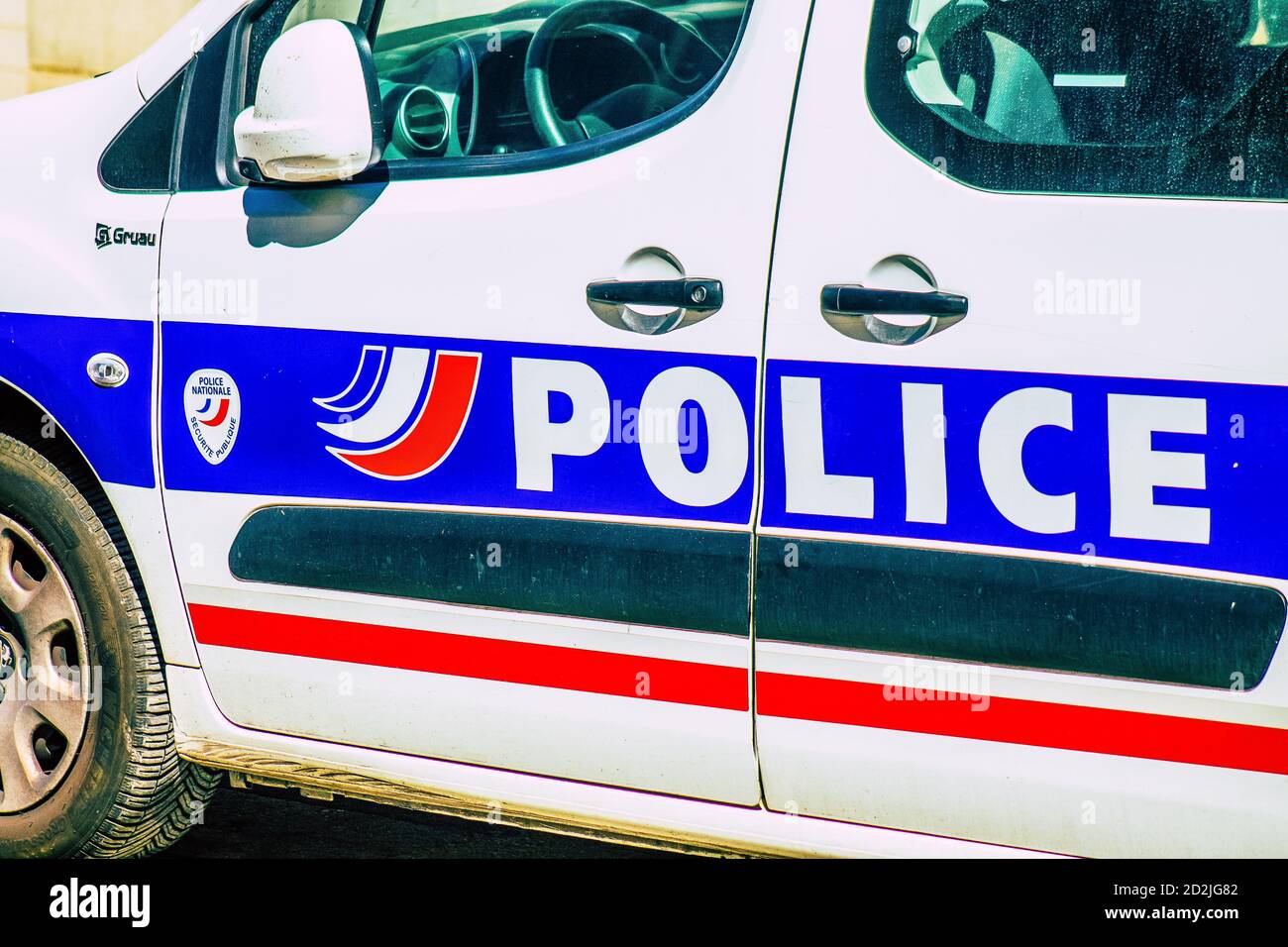 Closeup of an official police car patrolling the streets of the city ...