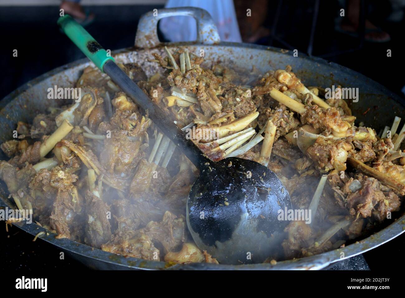 Cooking Tengkleng in big pan. goat meat with ribs and bone cooked with ...