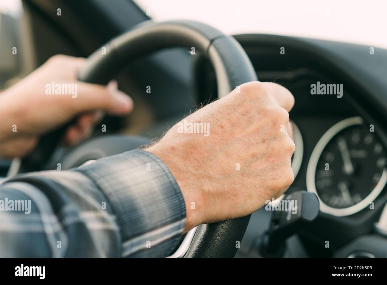 Mans hand holding steering wheel hi-res stock photography and images ...