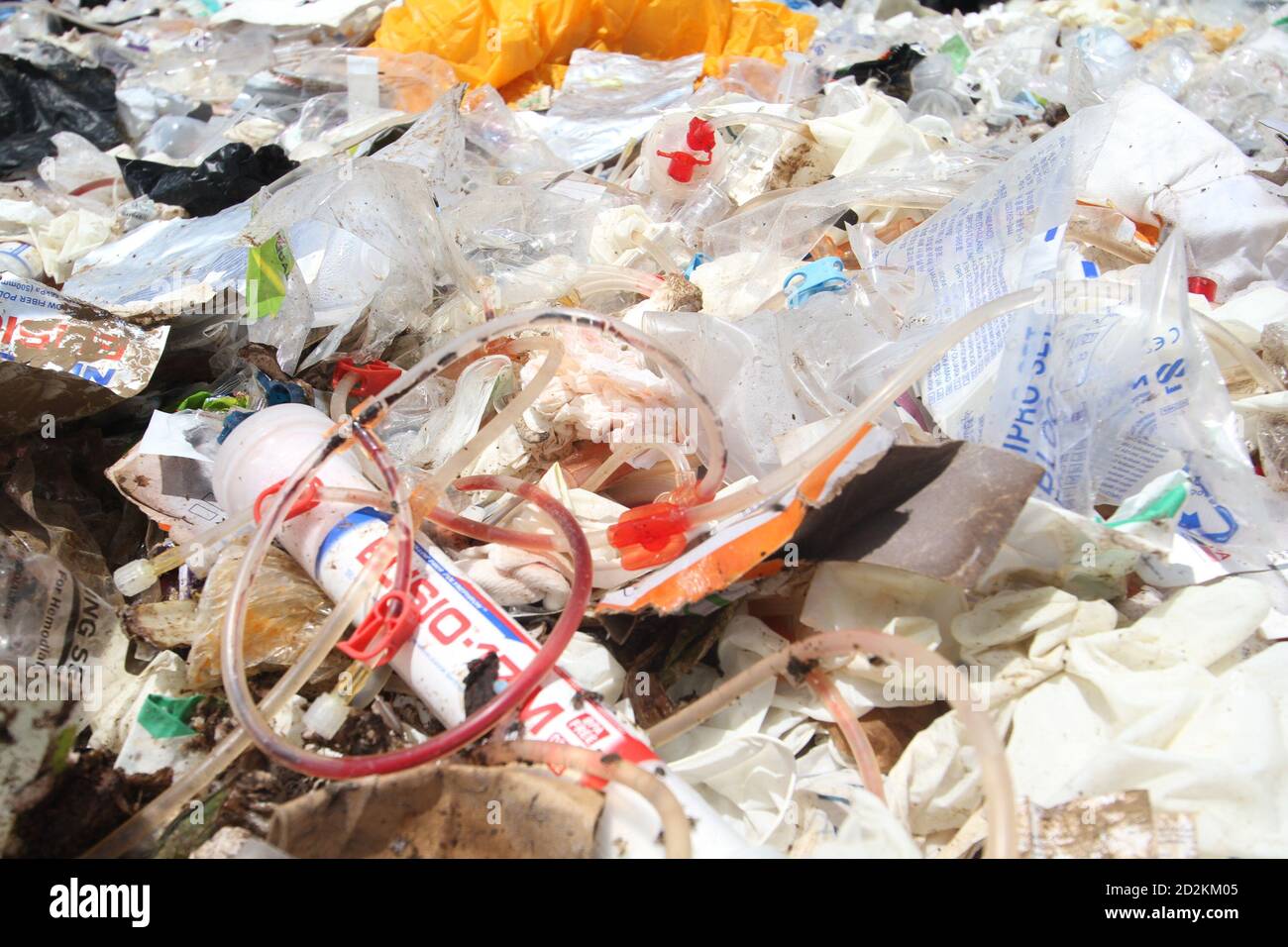 Medical waste mixed with general plastic waste at a local landfill in ...