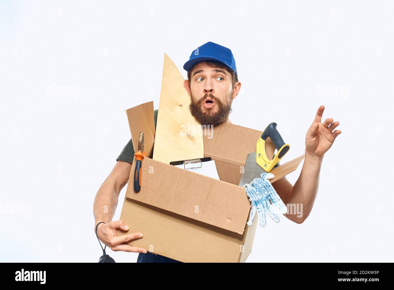 Worker man in uniform with a box in his hands tools delivery service ...
