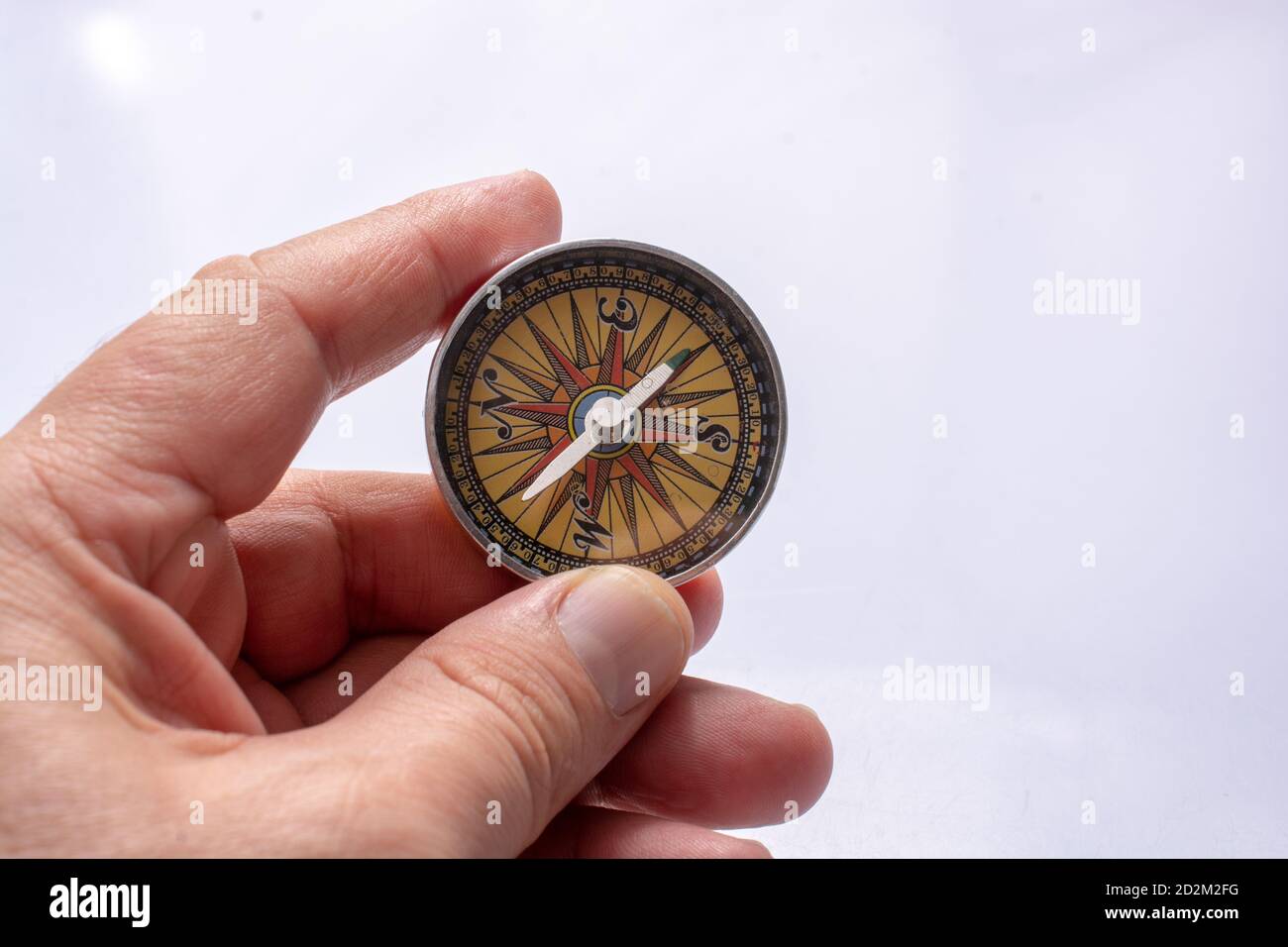 Compass tool in hand o as travel concept Stock Photo - Alamy