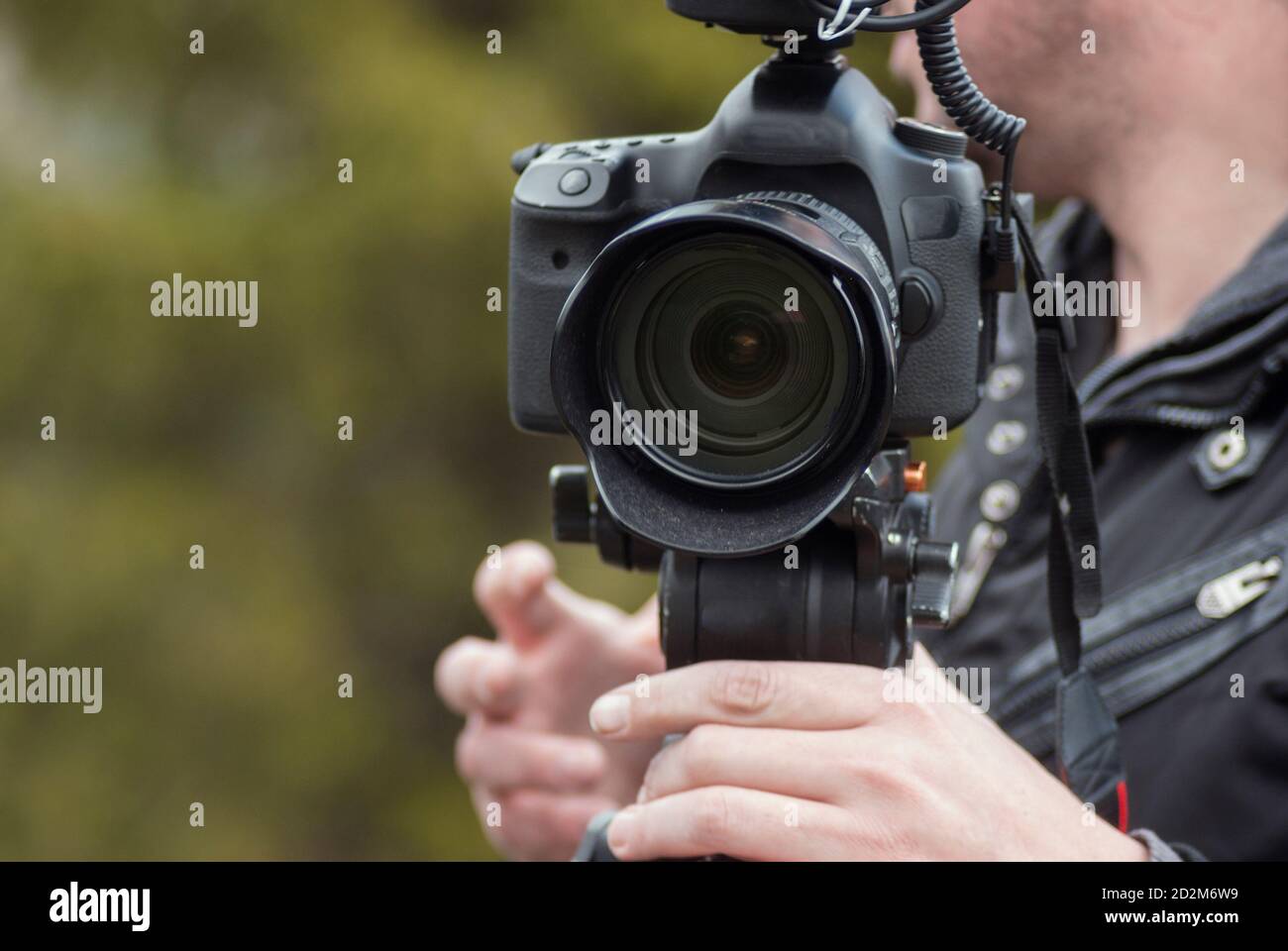 Man recording nature with modern camera on tripod Stock Photo - Alamy