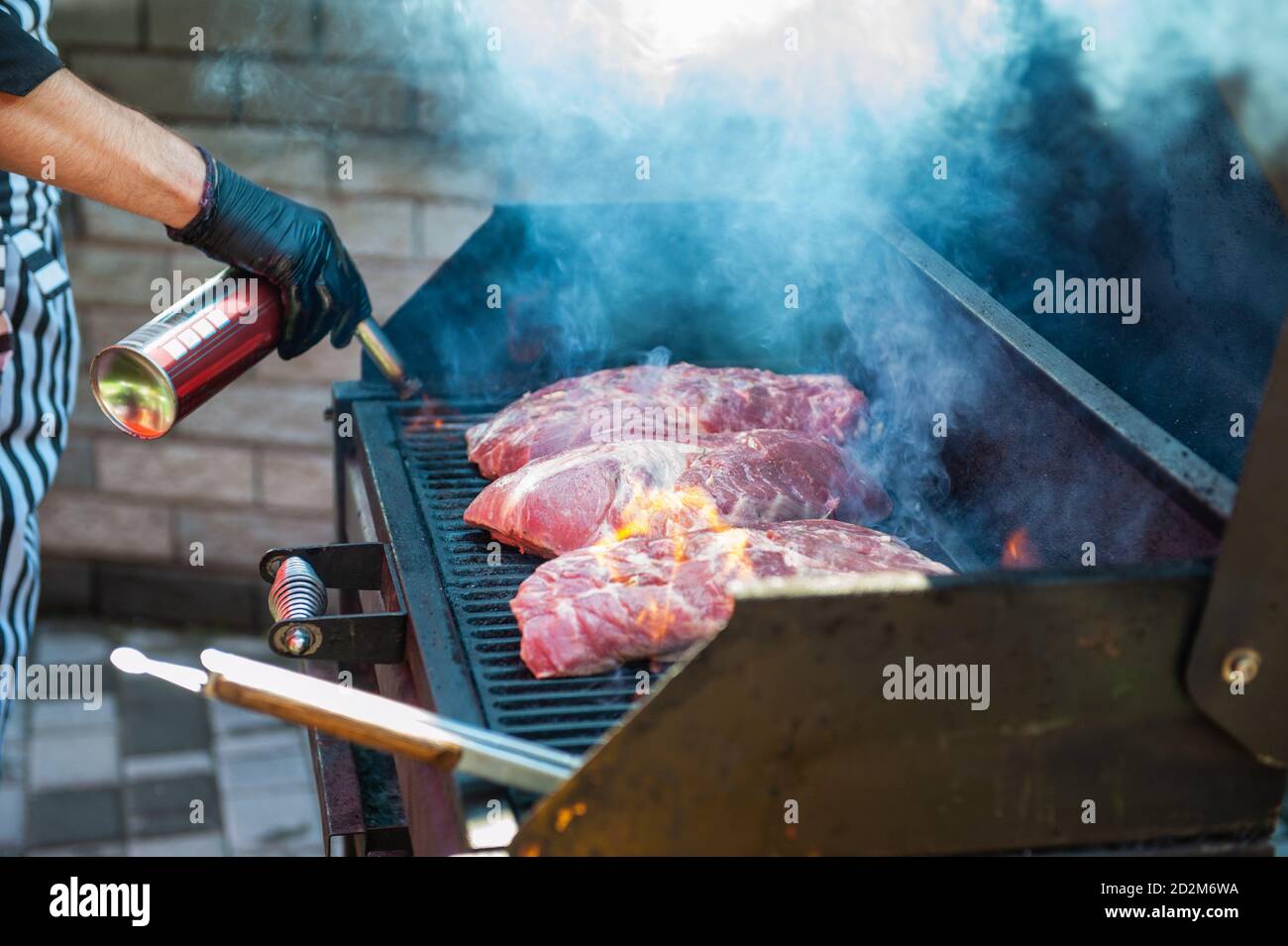 Pork meat steaks on the grill Stock Photo - Alamy