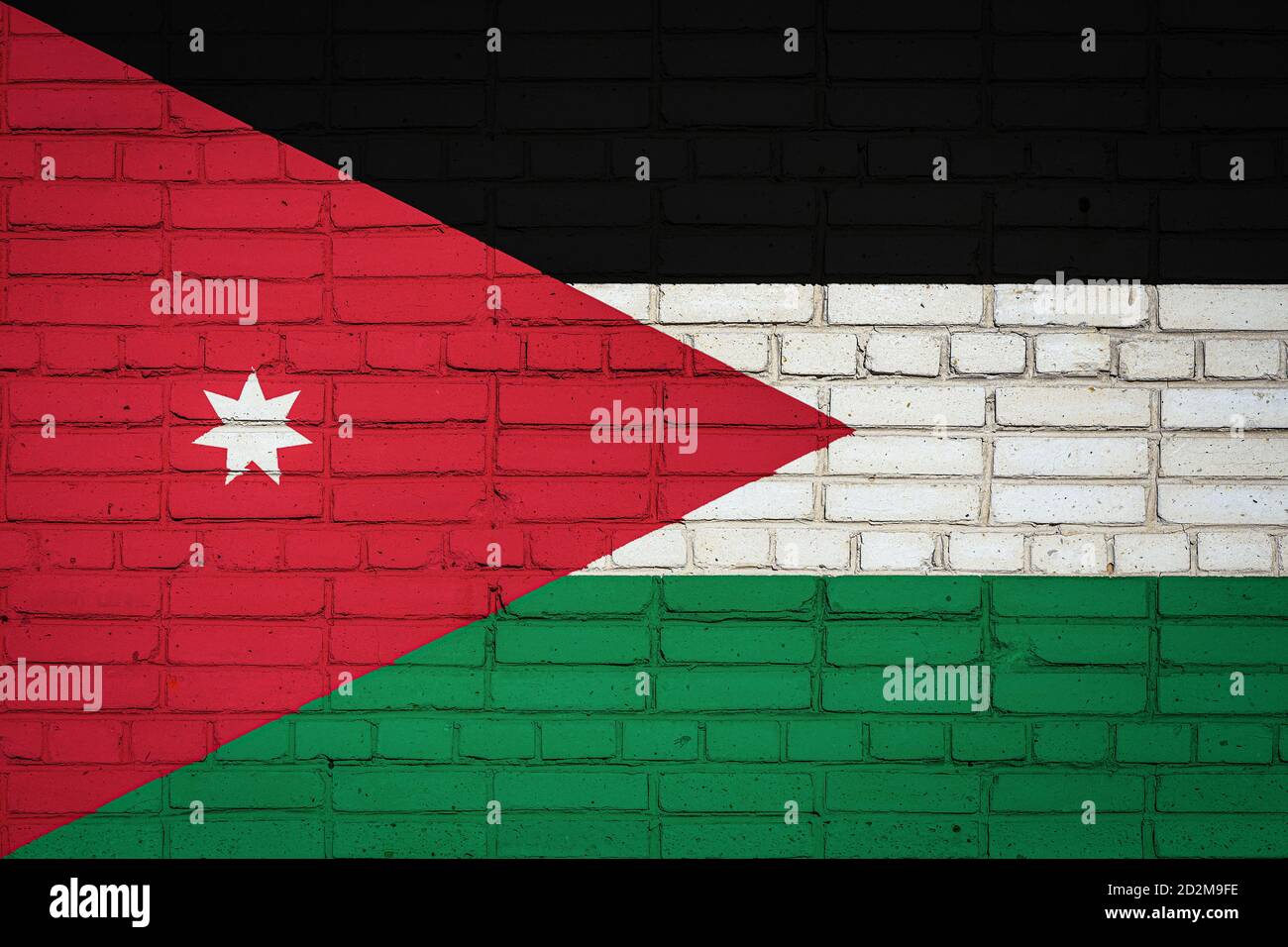 National flag of Jordan depicting in paint colors on an old brick wall ...