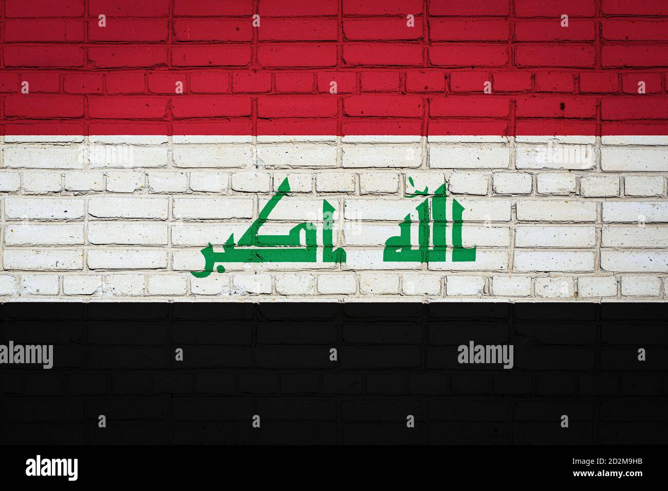 National flag of Irak depicting in paint colors on an old brick wall ...