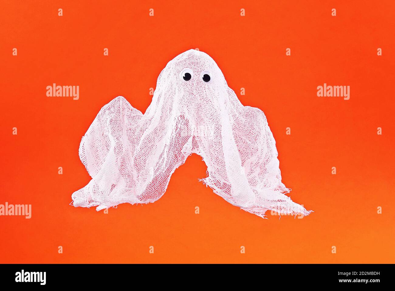 Diy Halloween ghost of starch and gauze on orange background. Gift idea ...