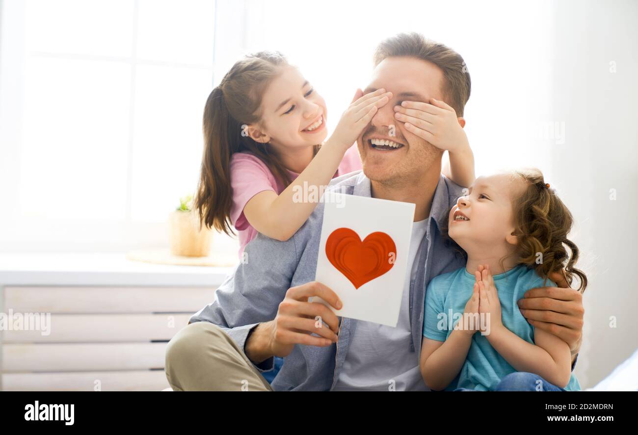 Happy father's day! Children daughters congratulating dad and giving ...
