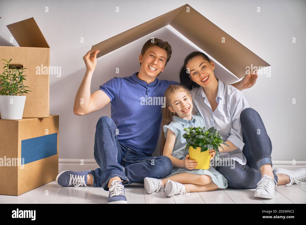 Mother, father and child girl in the house with a symbol of roof ...