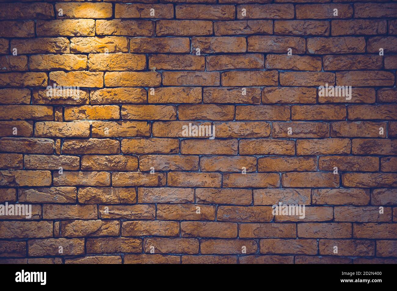 Light brick wall with lighting. Wall of brown color Stock Photo - Alamy