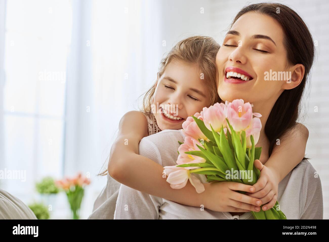 Happy mother's day! Child daughter congratulates mom and gives her ...