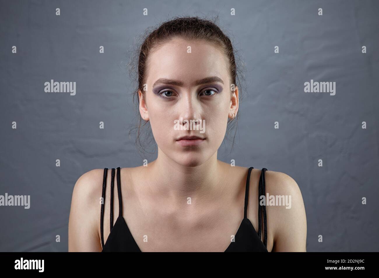 Image of girl with unfinished makeup on grey background Stock Photo - Alamy