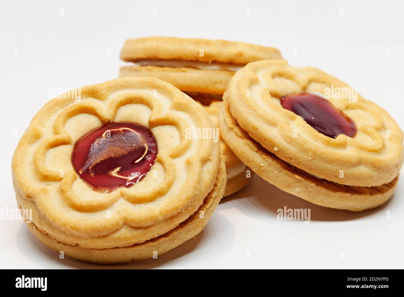 several biscuits with jam in the middle on white background Stock Photo ...