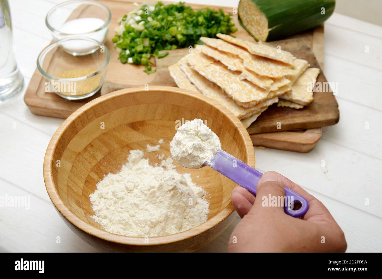 puting several spoon of flour, to make a dough, preparing making tempe ...