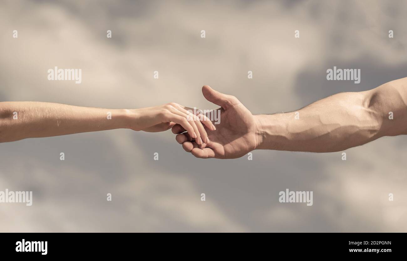 Giving a helping hand. Hands of man and woman on blue sky background ...
