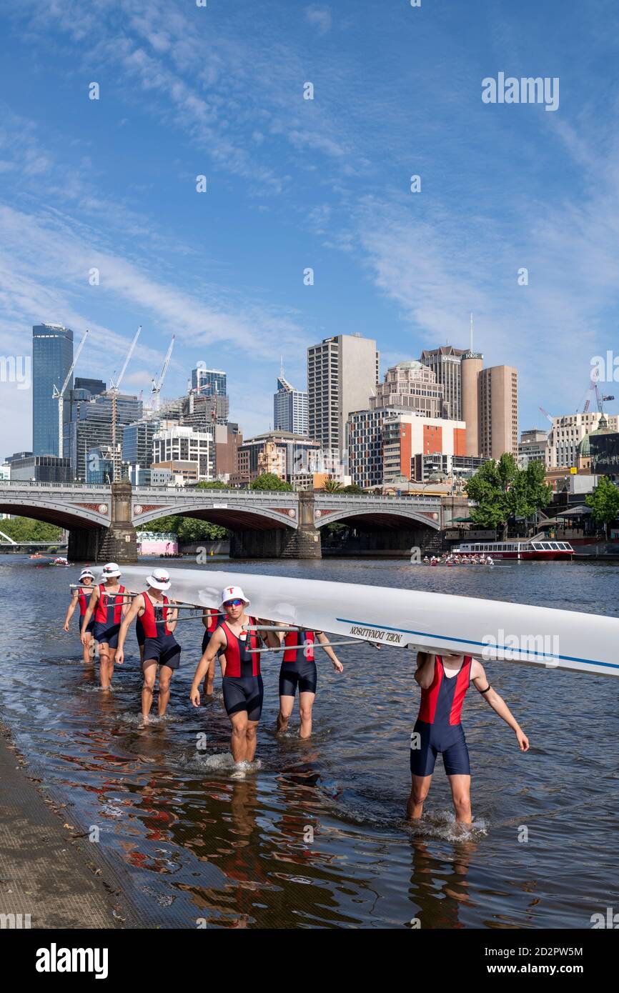 Young men move their rowing boat Stock Photo - Alamy
