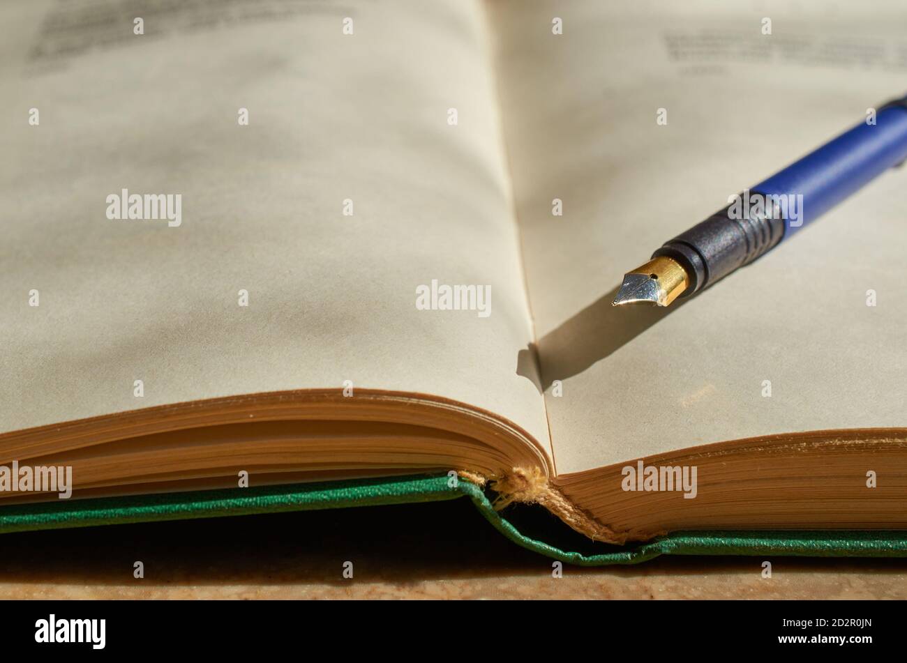 The fountain pen is lying on the open book. Close up. Macro Stock Photo ...
