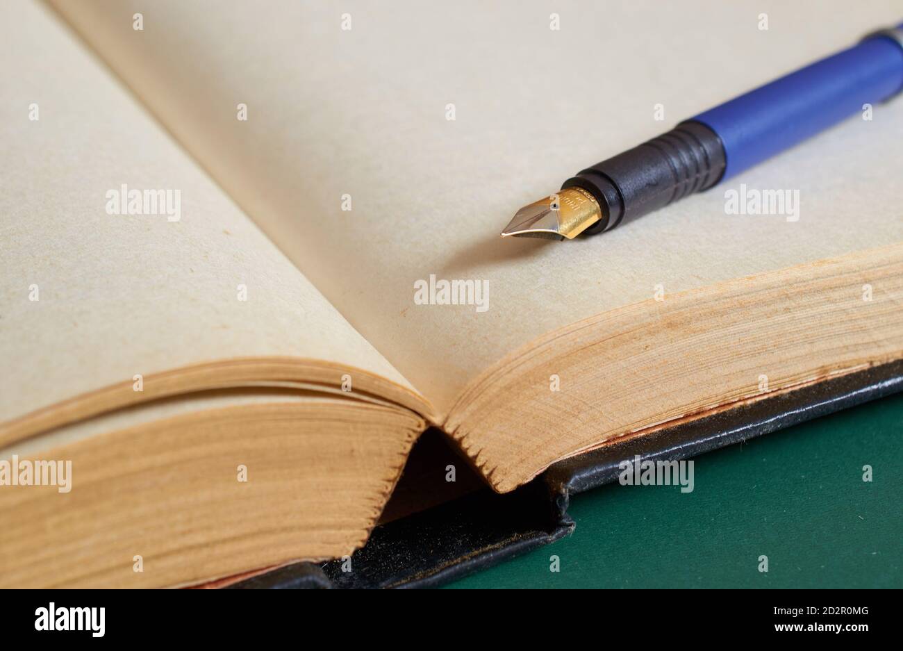 The fountain pen is lying on the open book. Close up. Macro Stock Photo ...