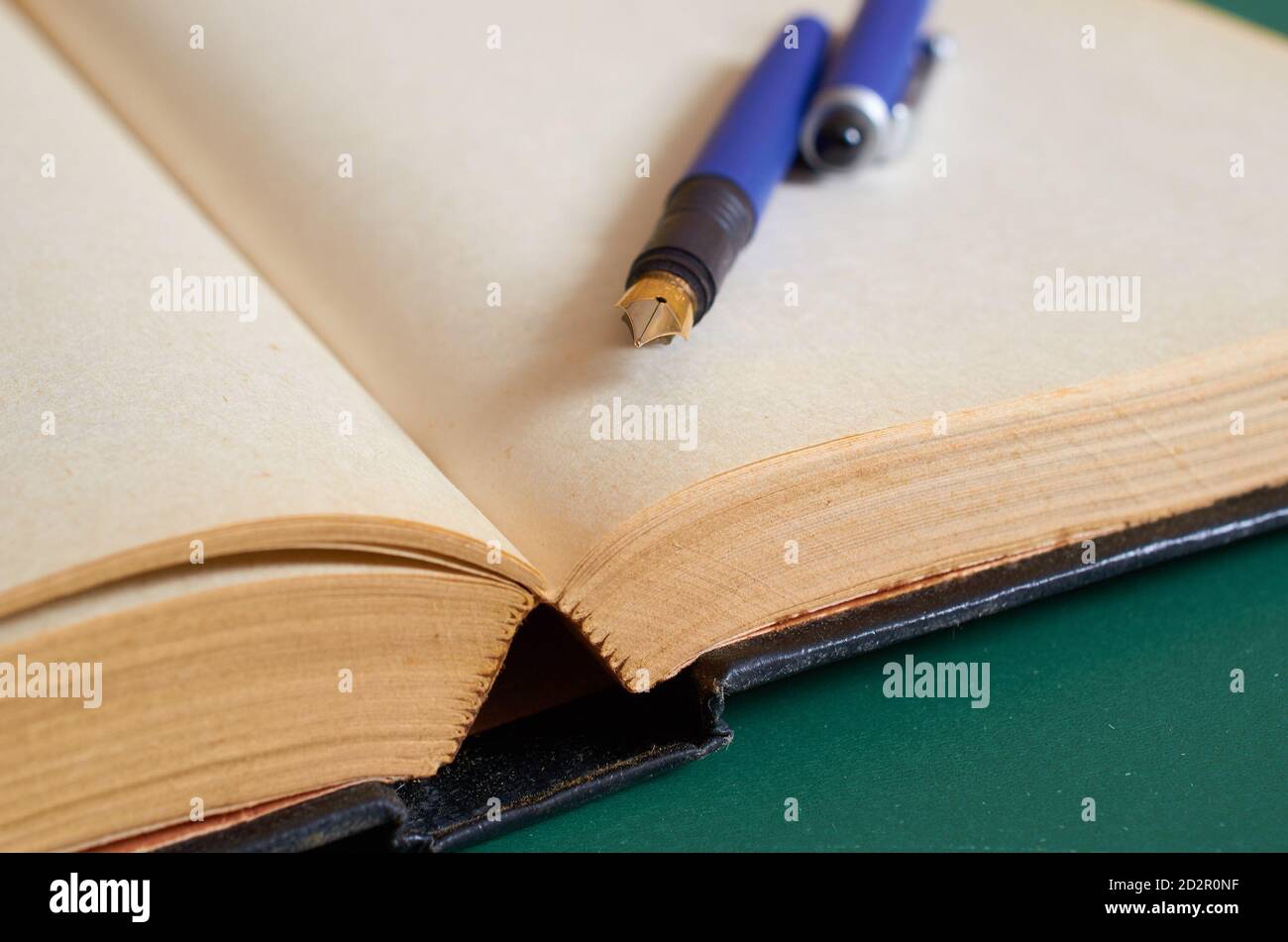 The fountain pen is lying on the open book. Close up. Macro Stock Photo ...