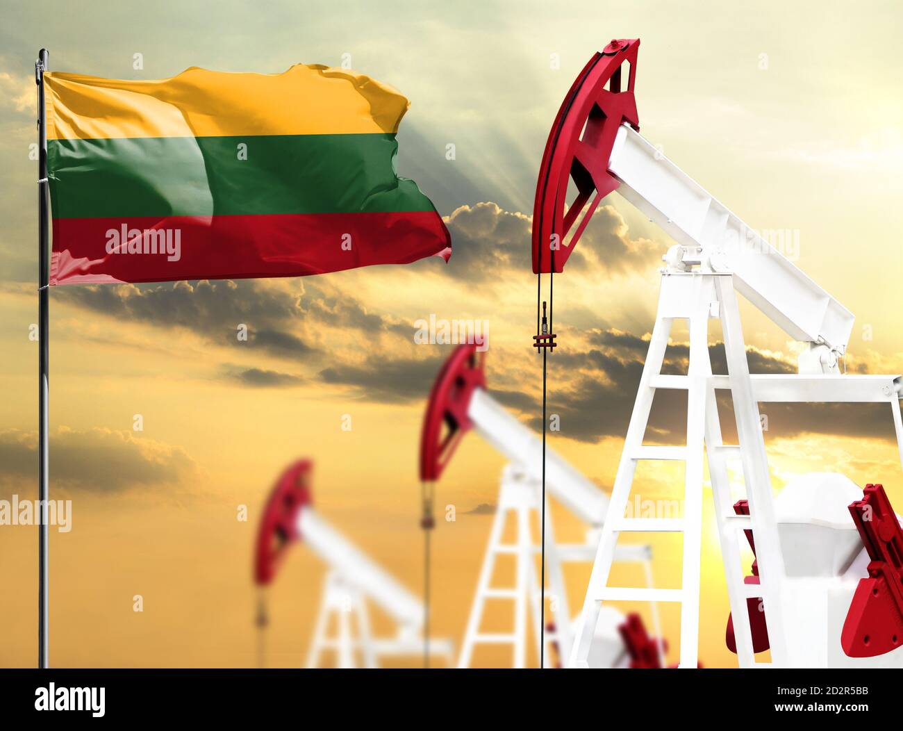 Oil rigs against the backdrop of the colorful sky and a flagpole with ...