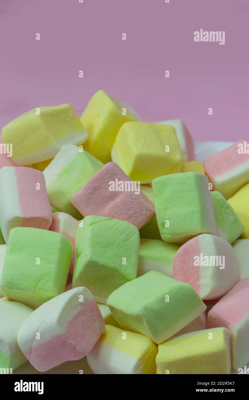 Lots of multi-colored marshmallows close-up. Fruit sweets, light ...