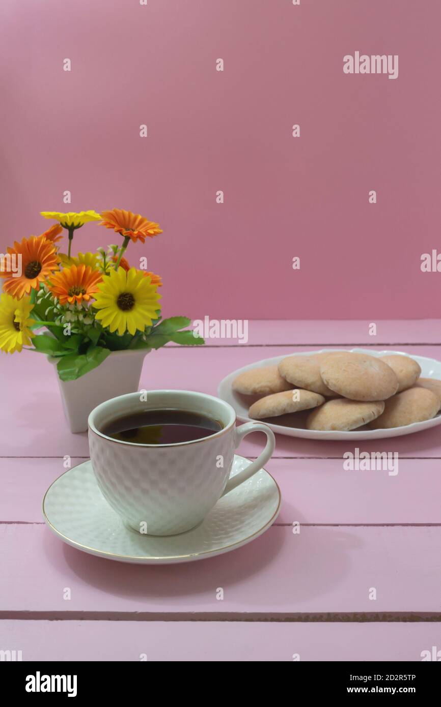 Cup of Americano coffee and homemade pastries on pink background ...
