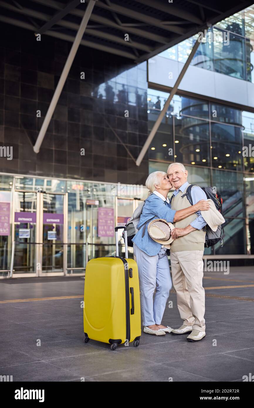 Affectionate lady giving a kiss to her spouse Stock Photo - Alamy
