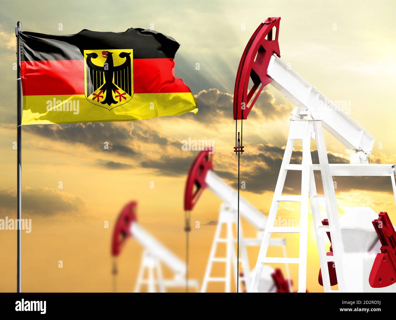 Oil rigs against the backdrop of the colorful sky and a flagpole with ...