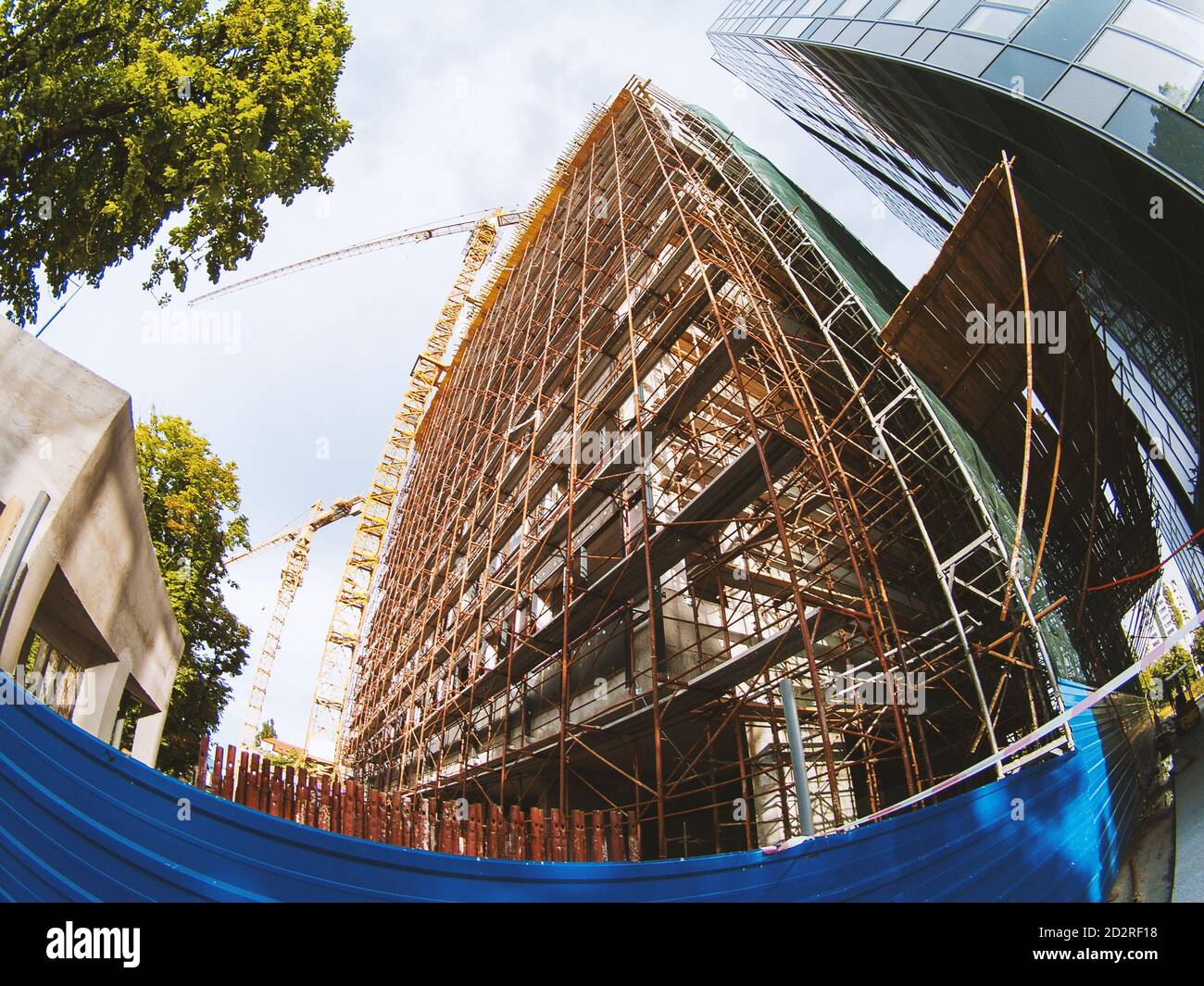 Building of modern architecture in the city center with crane and ...