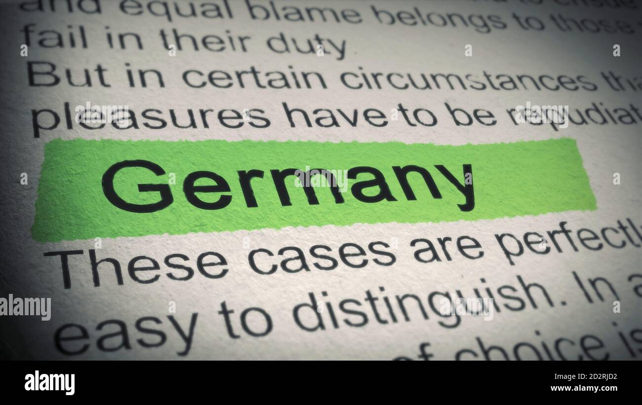 Germany. Highlighter pen marks word in Newspaper. Closeup. Thumbing ...