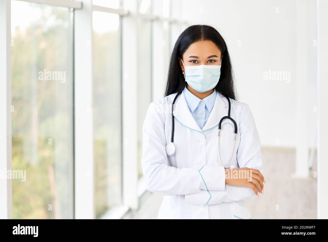 Female doctor wearing medical mask with arms crossed in hospital ...